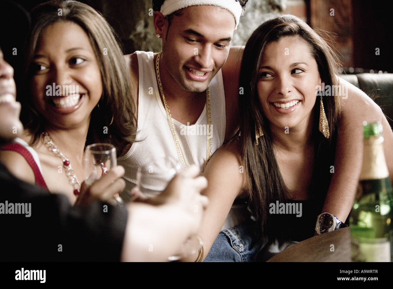 Close-up of group of young friends socializing Stock Photo - Alamy
