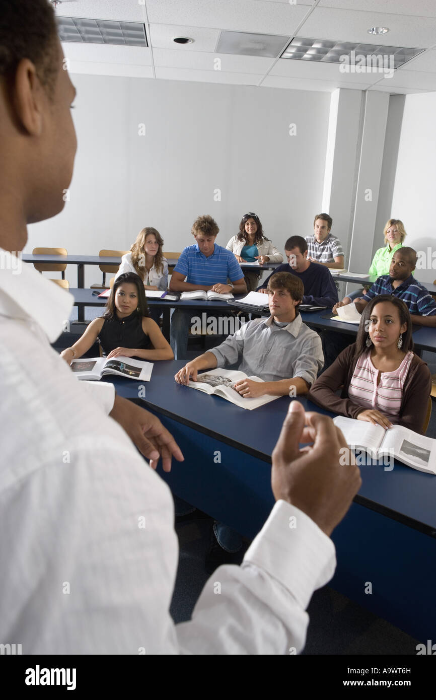 Teacher teaching students in the classroom Stock Photo - Alamy