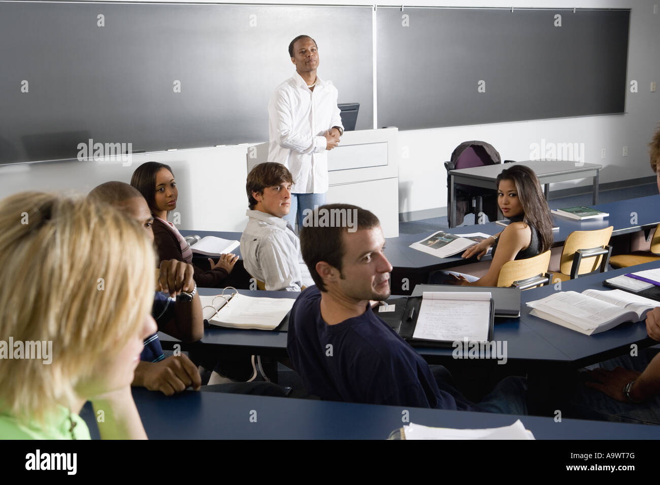 Teacher teaching students in the classroom Stock Photo - Alamy