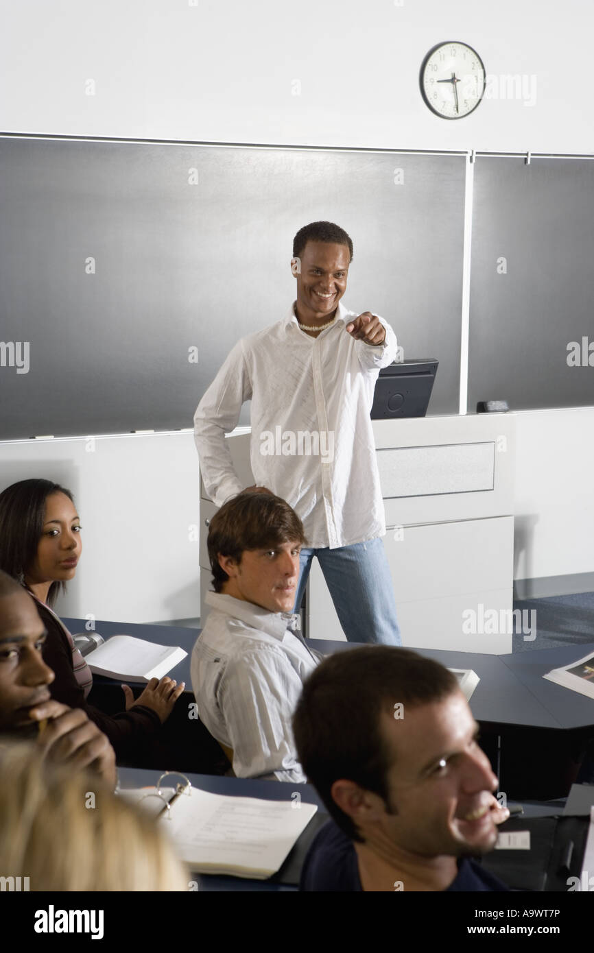 Teacher teaching students in the classroom Stock Photo - Alamy