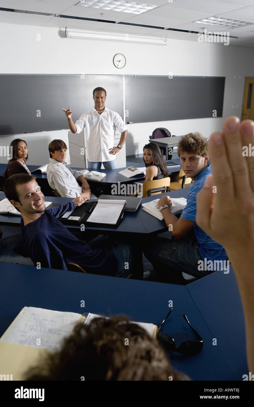 Teacher teaching students in the classroom Stock Photo - Alamy