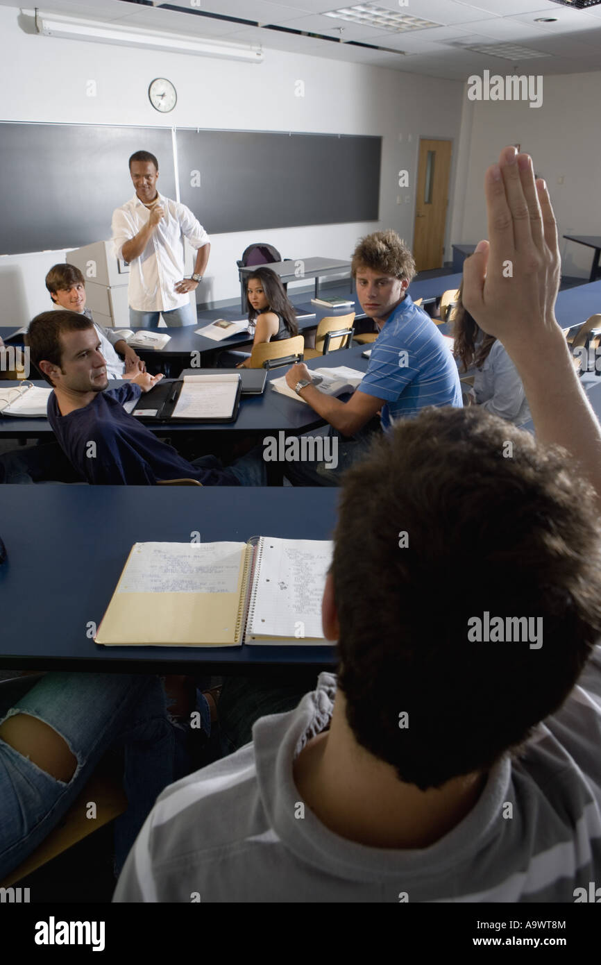 Student raising hand in the classroom Stock Photo - Alamy