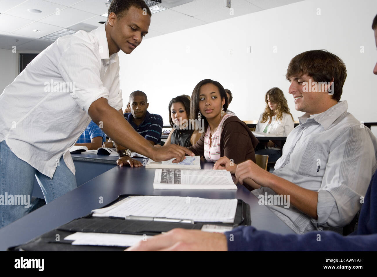 Teacher teaching students in the classroom Stock Photo - Alamy