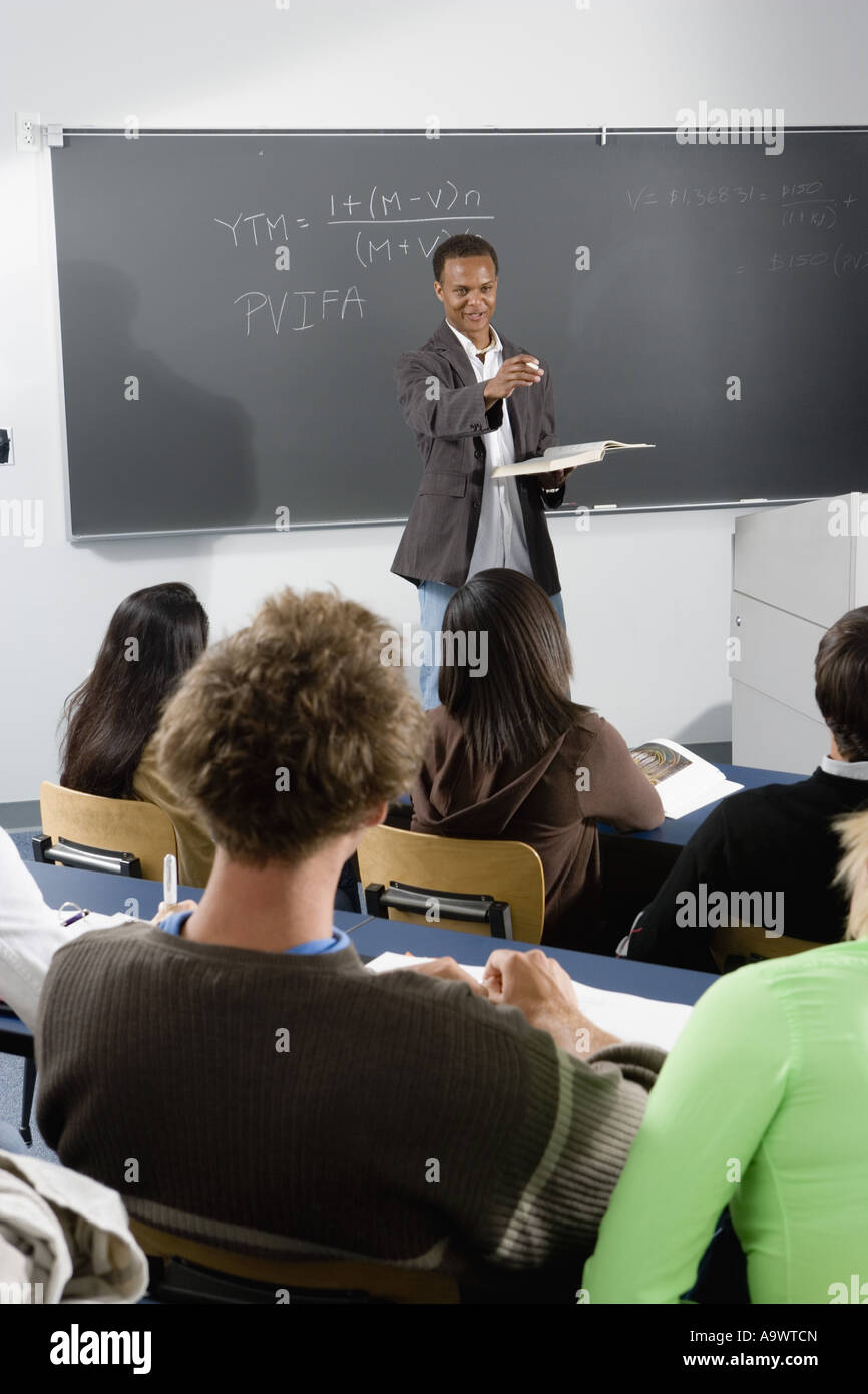 Teacher teaching students in the classroom Stock Photo - Alamy