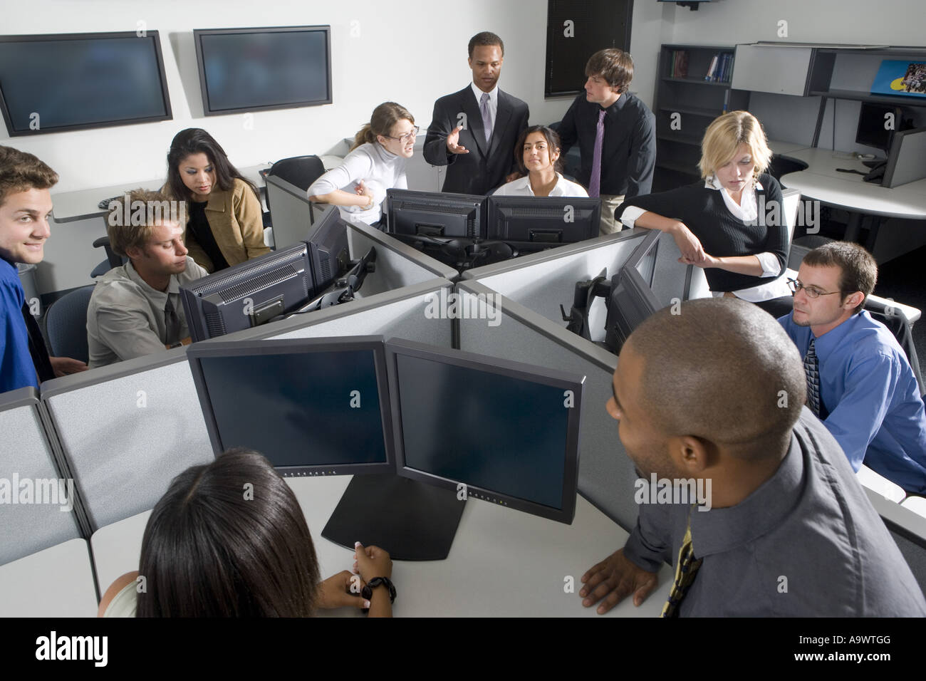 Group of young workers in office working on computers Stock Photo - Alamy