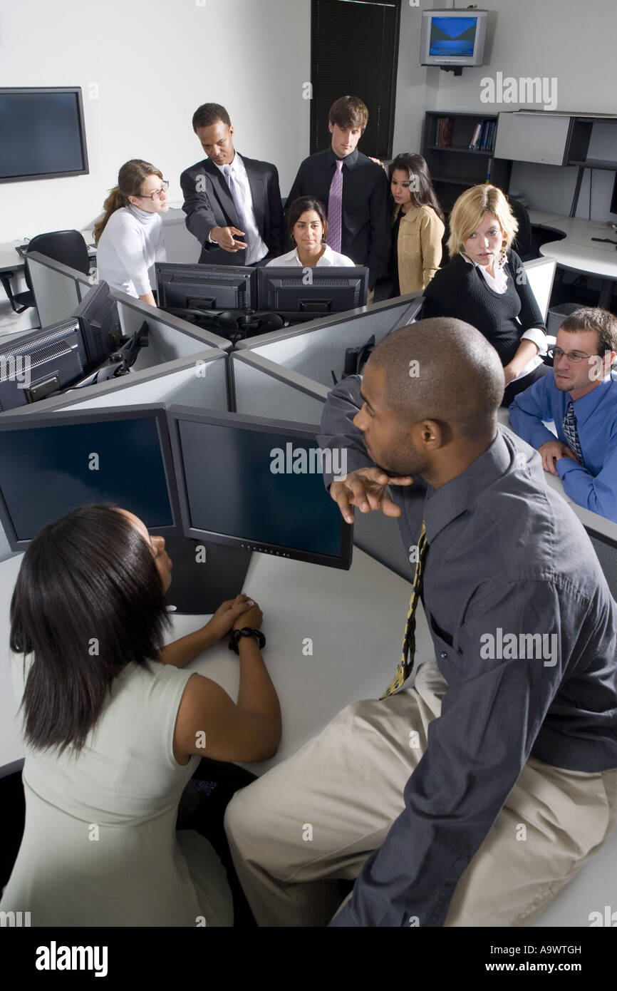 Group of young workers in office working on computers Stock Photo - Alamy