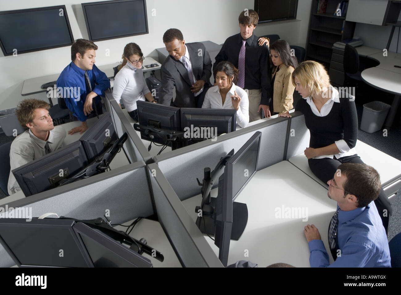 Group of young workers in office working on computers Stock Photo - Alamy