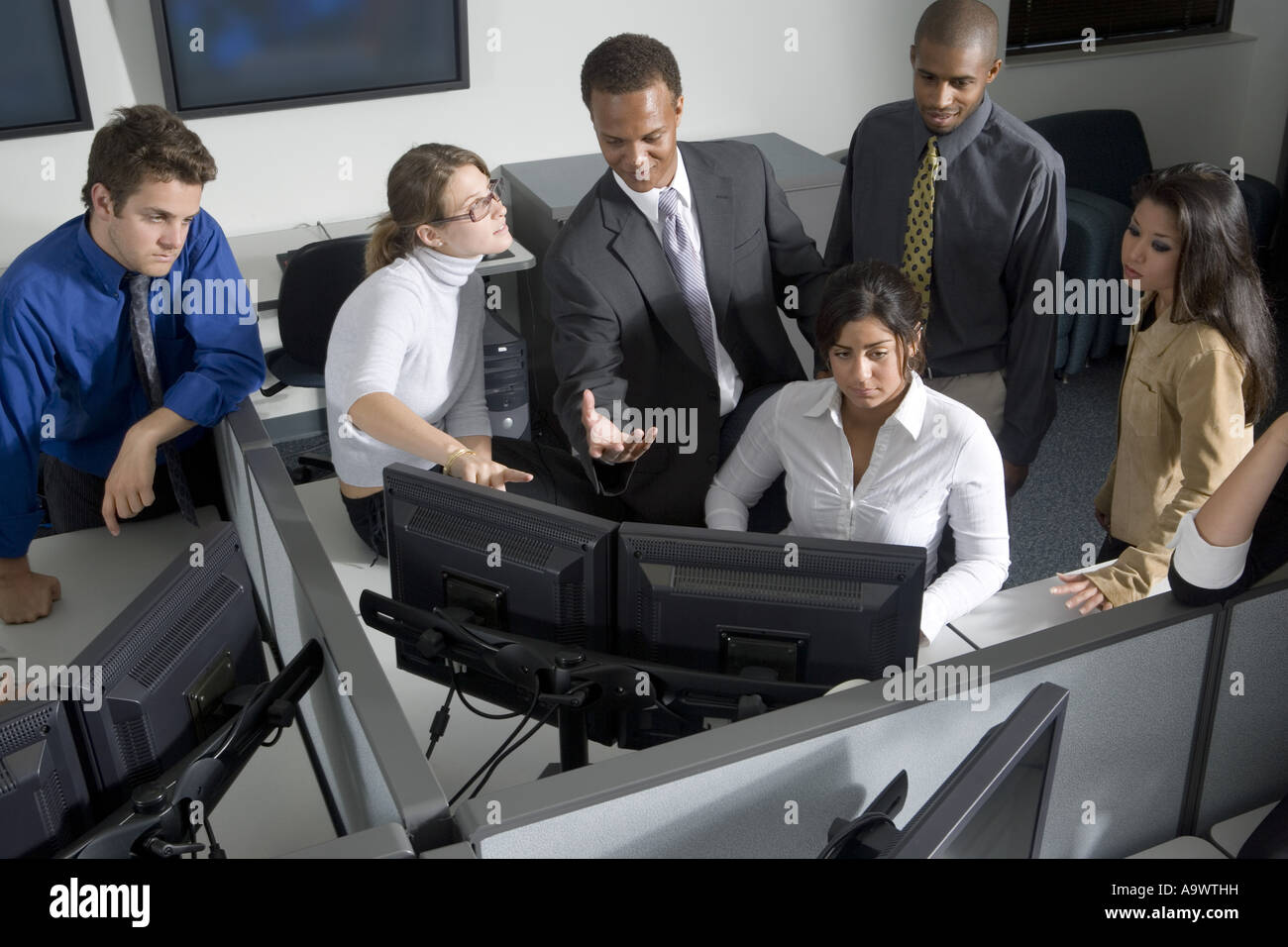 Group of young workers in office working on computers Stock Photo - Alamy