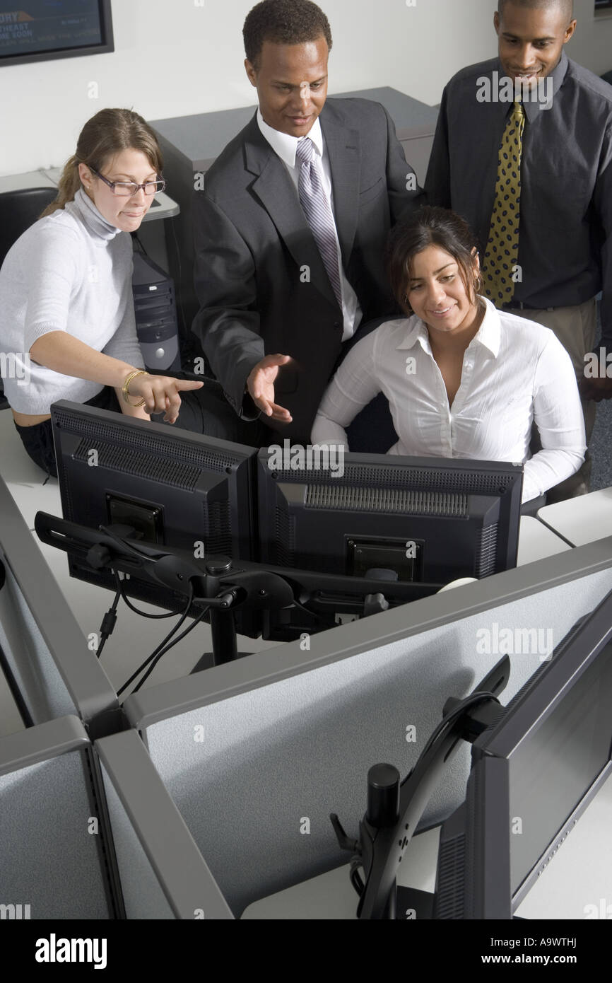 Group of young workers in office working on computers Stock Photo - Alamy