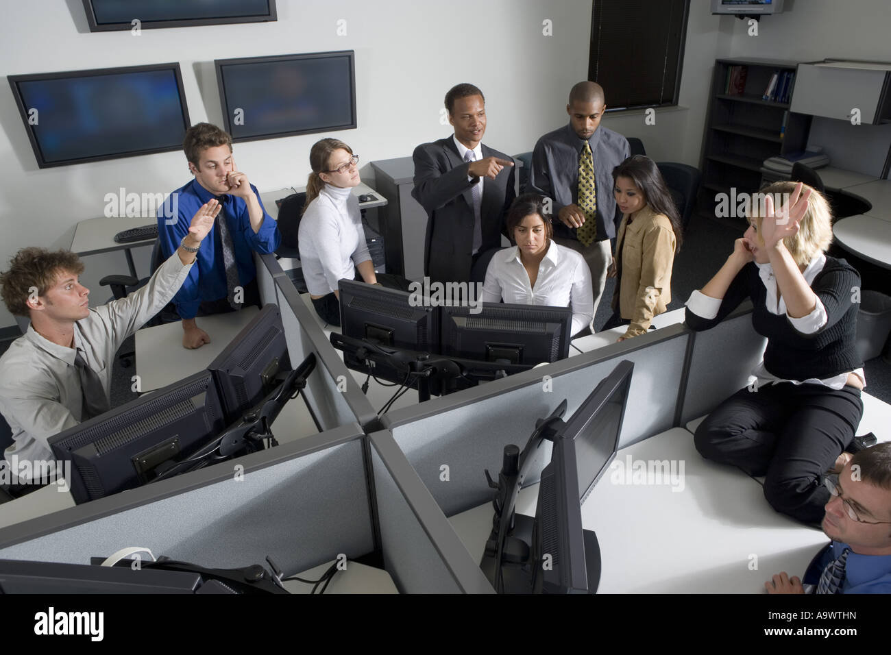 Group of young workers in office working on computers Stock Photo - Alamy