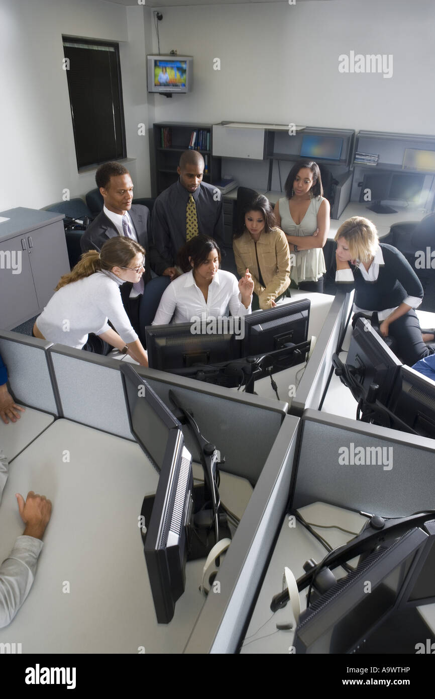Group of young workers in office working on computers Stock Photo - Alamy