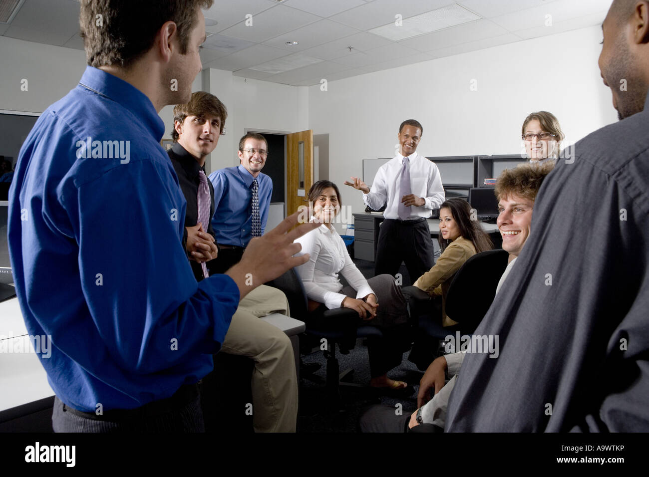 Group of young workers in office gathered for a meeting Stock Photo - Alamy