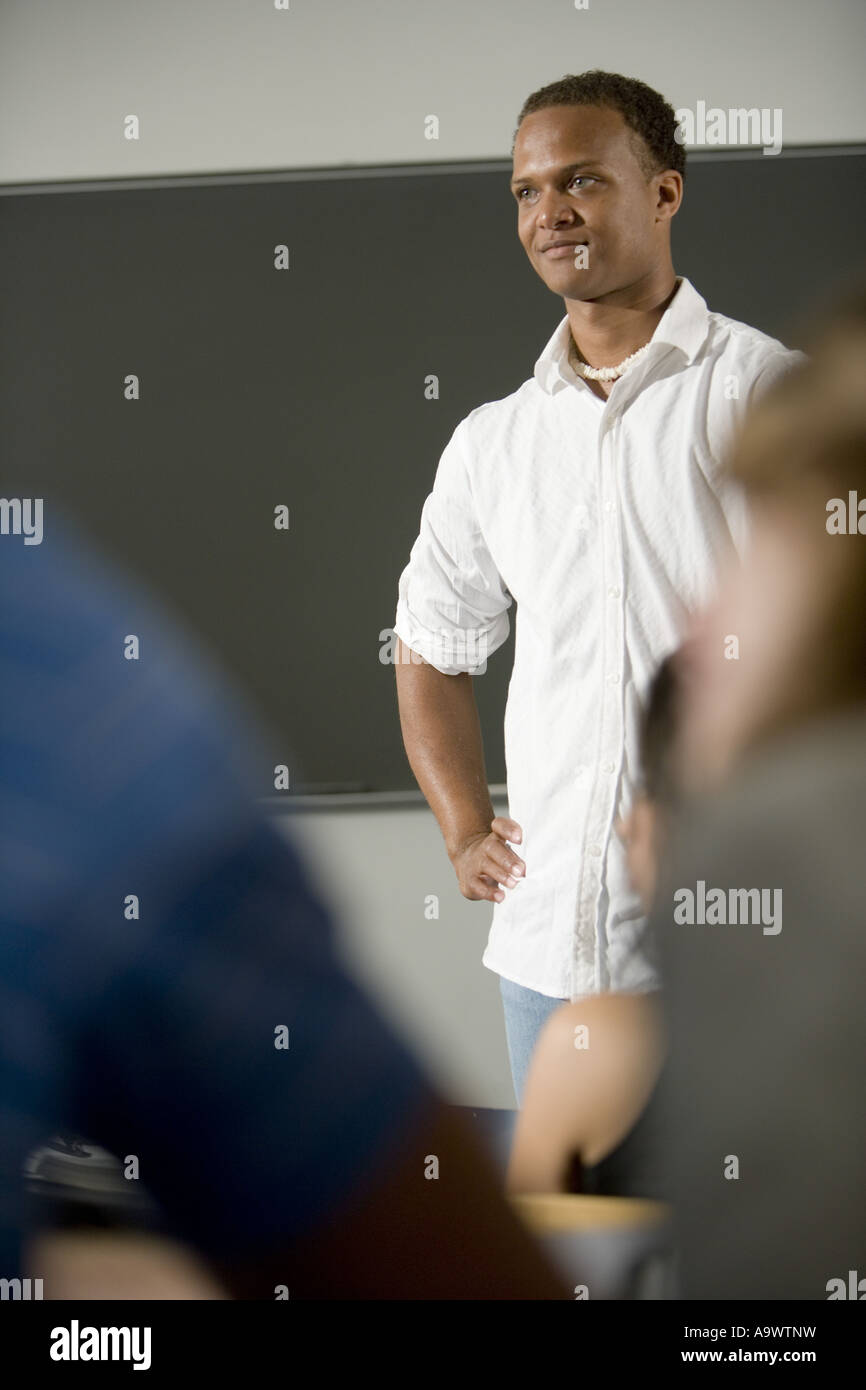 Teacher standing in the classroom Stock Photo - Alamy