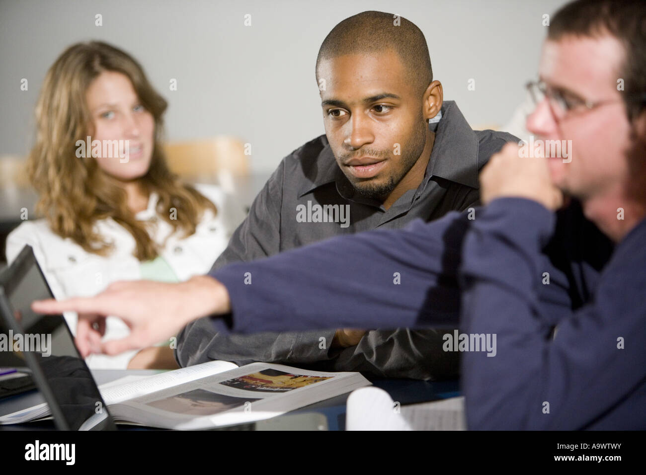 Students using textbook in class hi-res stock photography and images ...