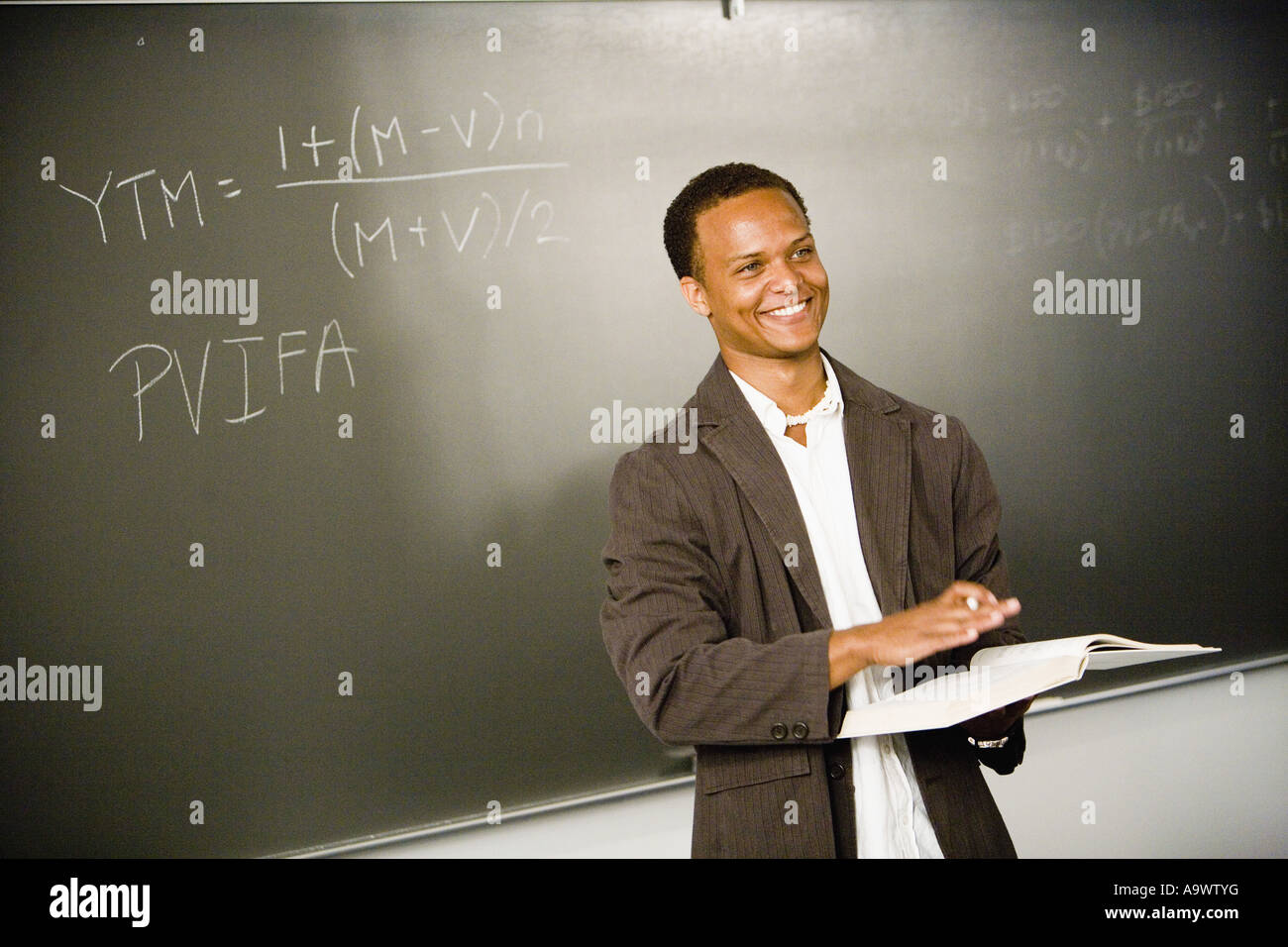 Front view teacher holding chalk hi-res stock photography and images ...
