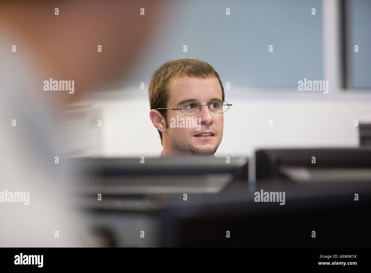 Young man behind computer monitors Stock Photo - Alamy