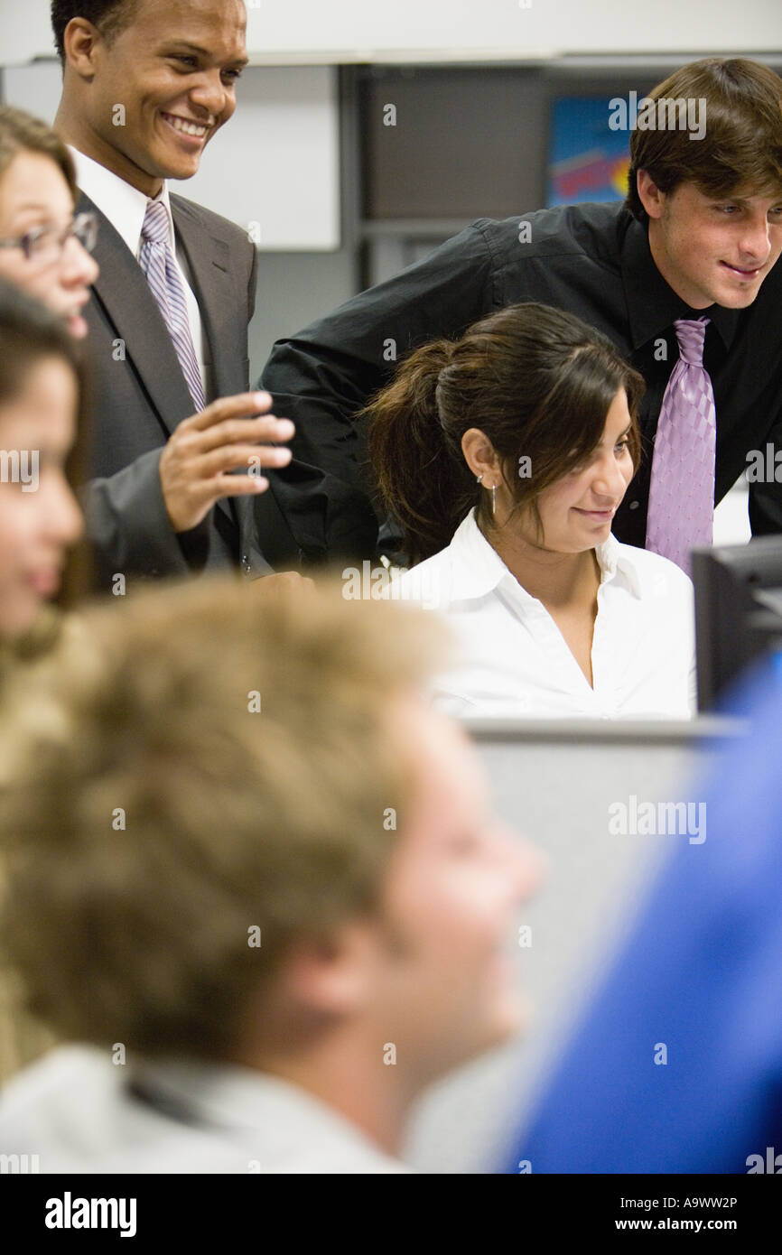 Office workers gathered around computer hi-res stock photography and ...