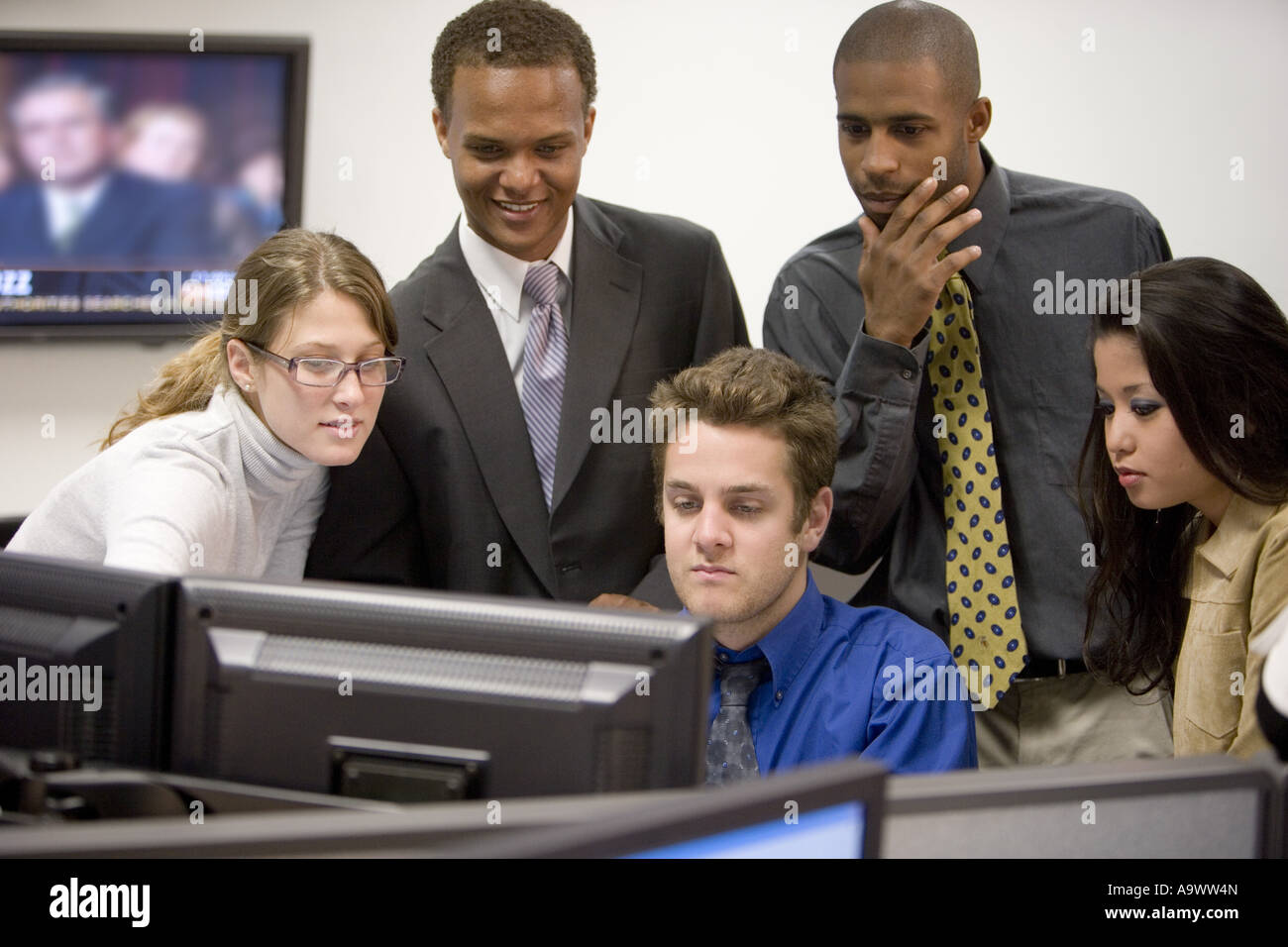 Office workers gathered around computer hi-res stock photography and ...