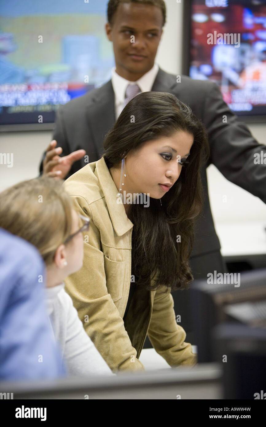 Office workers gathered around computer hi-res stock photography and ...