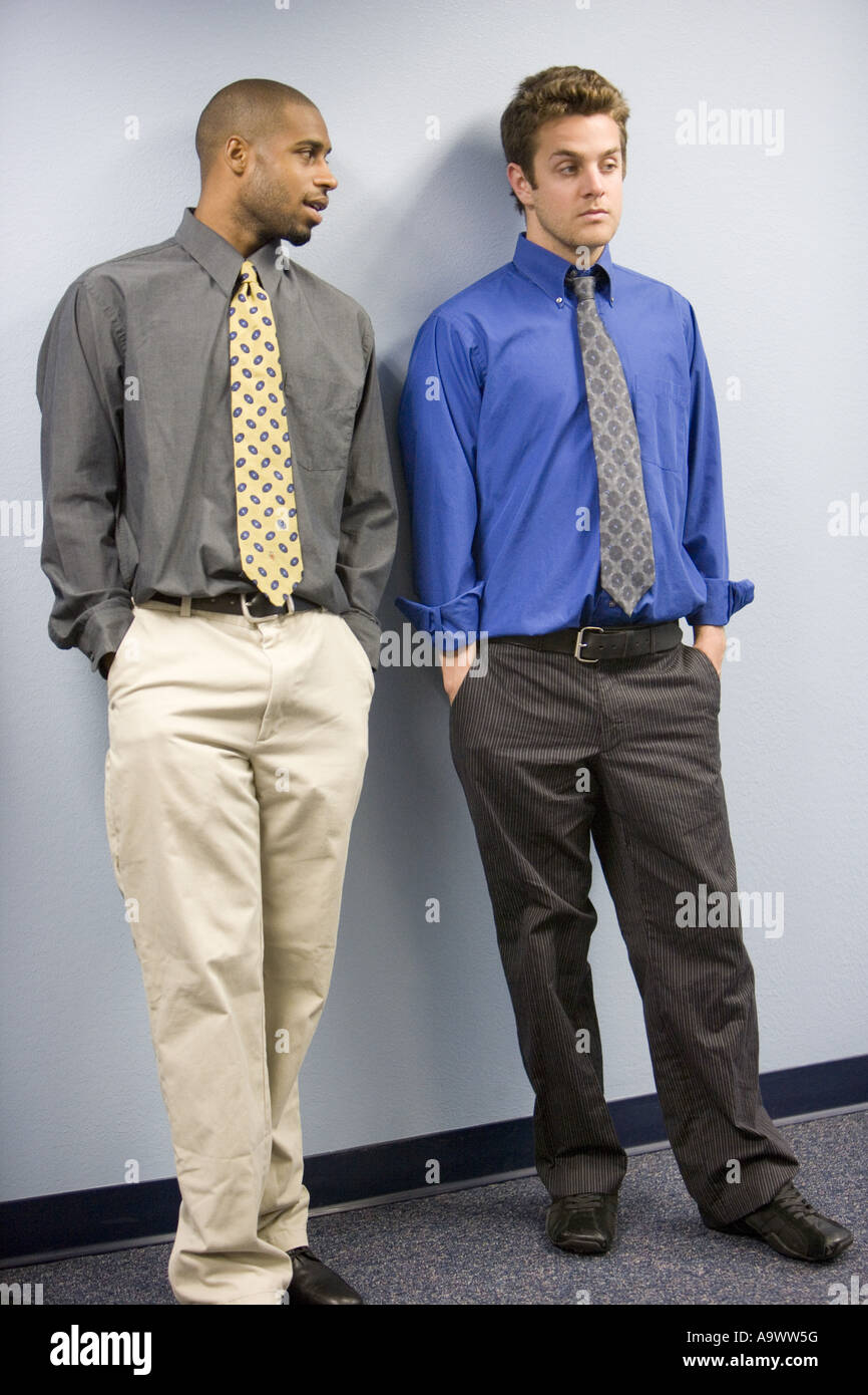 Two young businessmen standing Stock Photo - Alamy