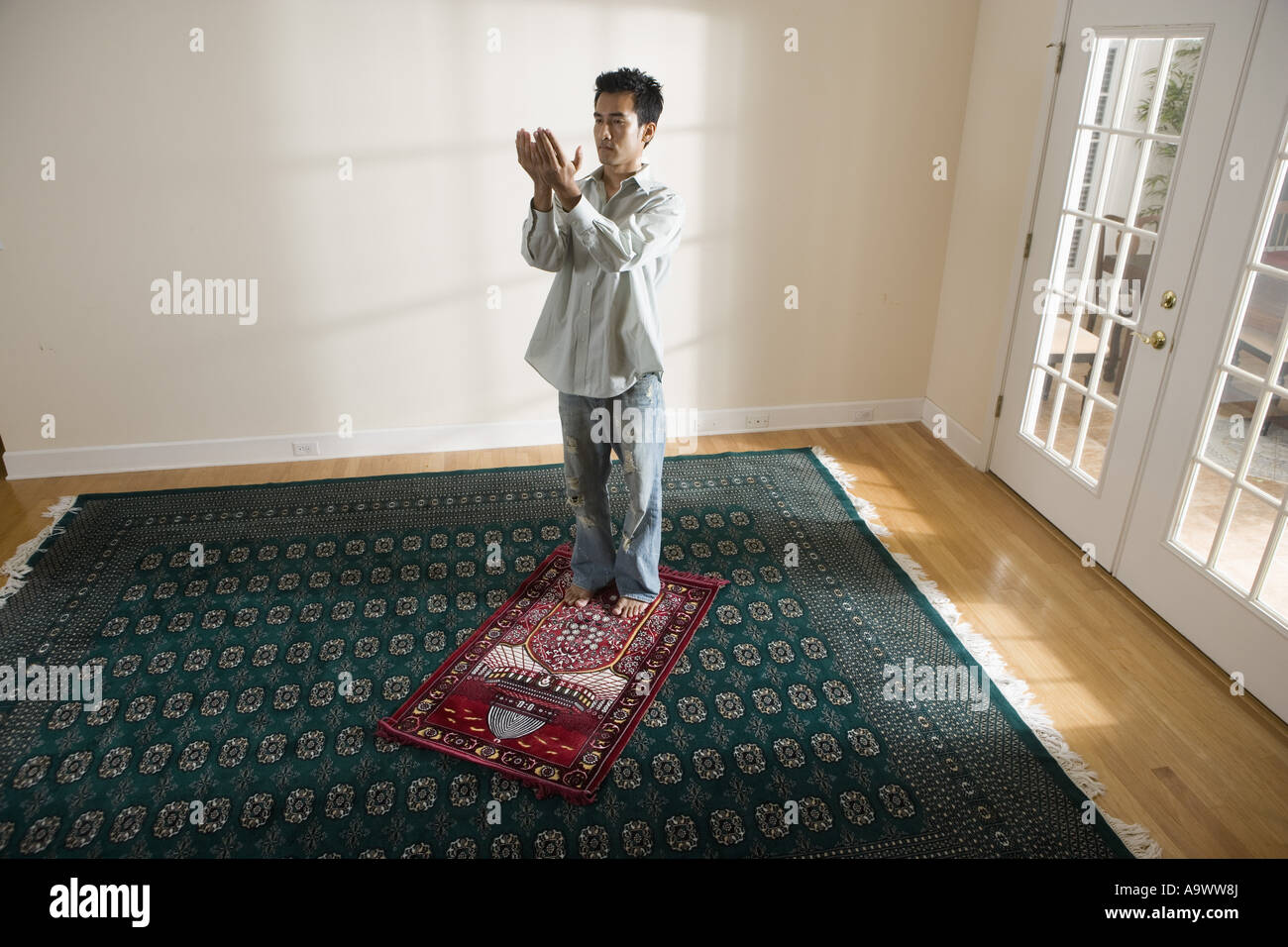 Man standing on prayer mat hi-res stock photography and images - Alamy
