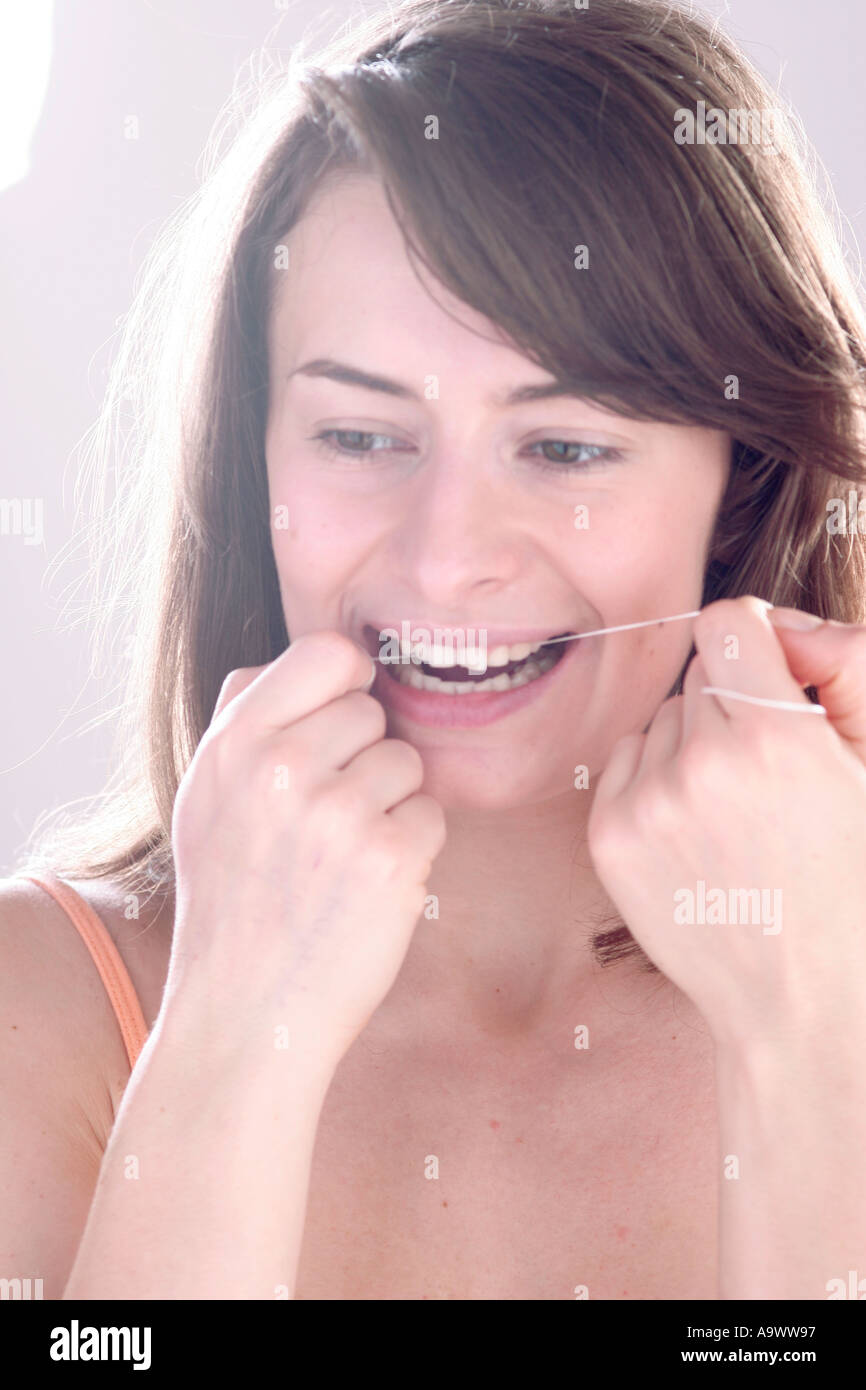Healthy young woman using dental floss flossing tooth teeth Stock Photo ...