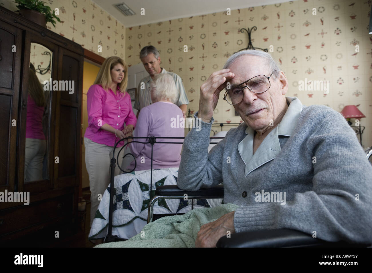Adult children visiting and comforting senior parents in bedroom Stock ...