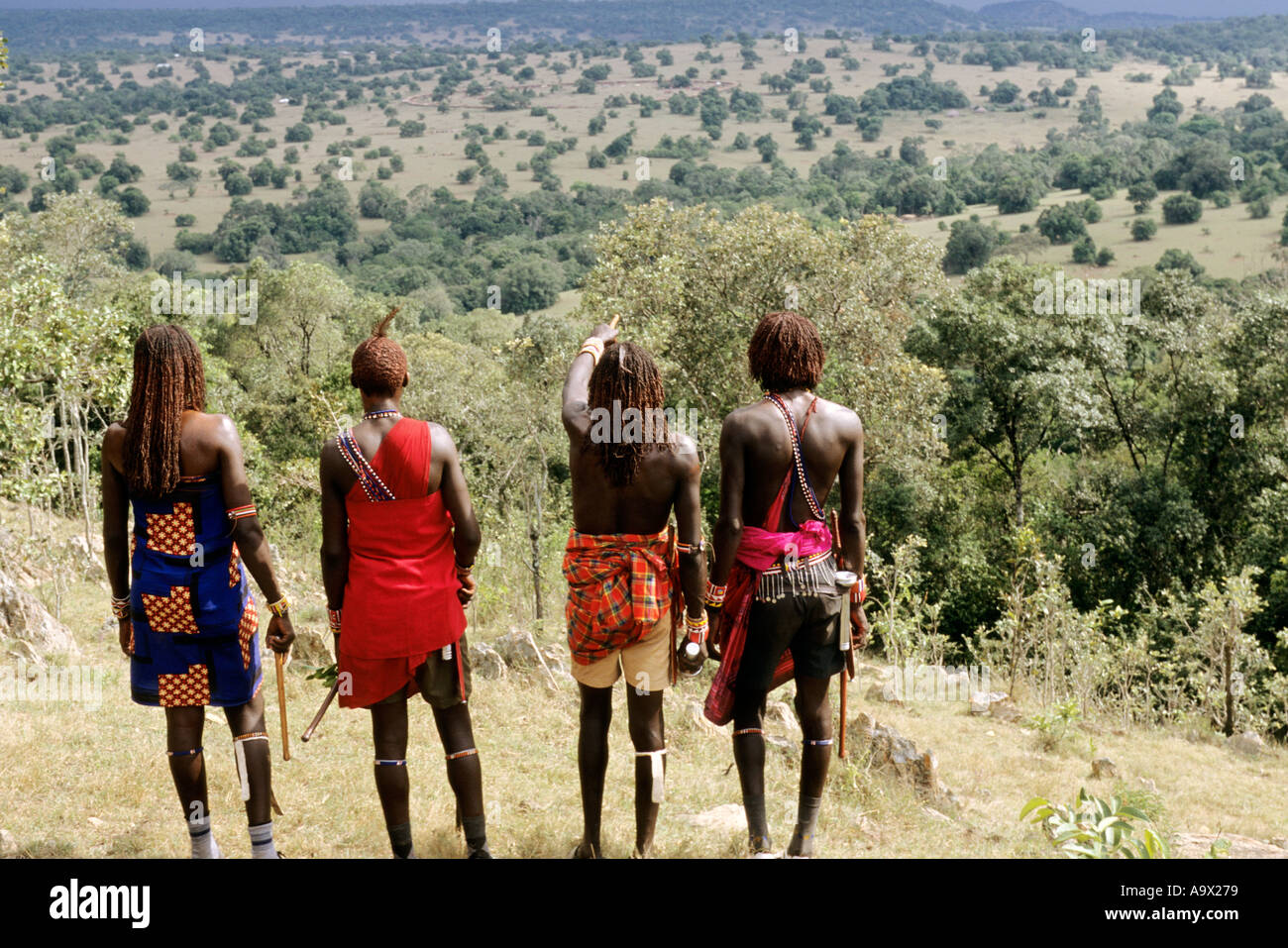 Lolgorian, Kenya. Siria Maasai Manyatta; four moran warriors standing ...