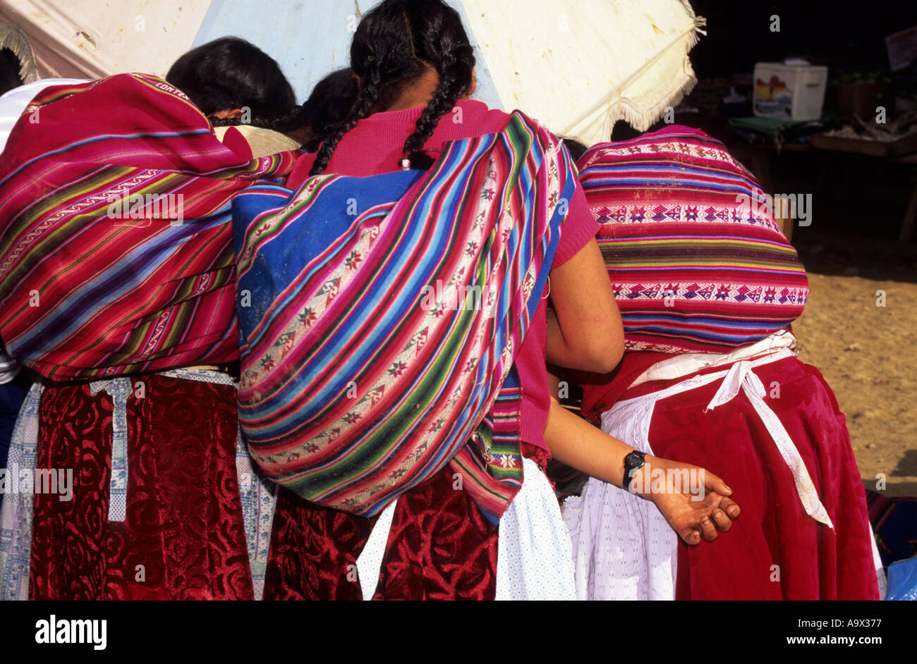 San Juan del Oro, Peru. Three women with manta bundles from the back ...