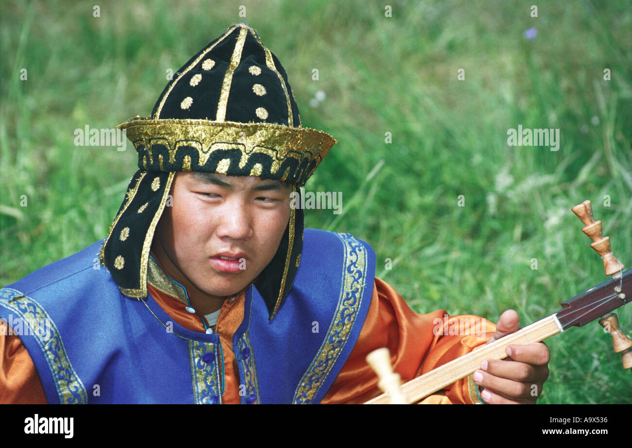 Man in Altaic costume is playing national music instrument topshur and ...