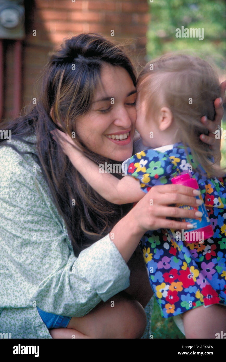 Mom Daughter hugs Stock Photo - Alamy