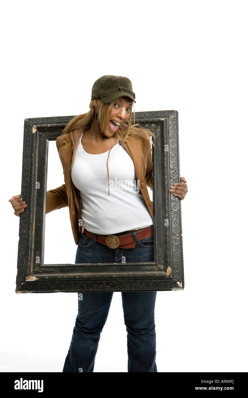 Pretty young woman happily posing with a picture frame Stock Photo - Alamy