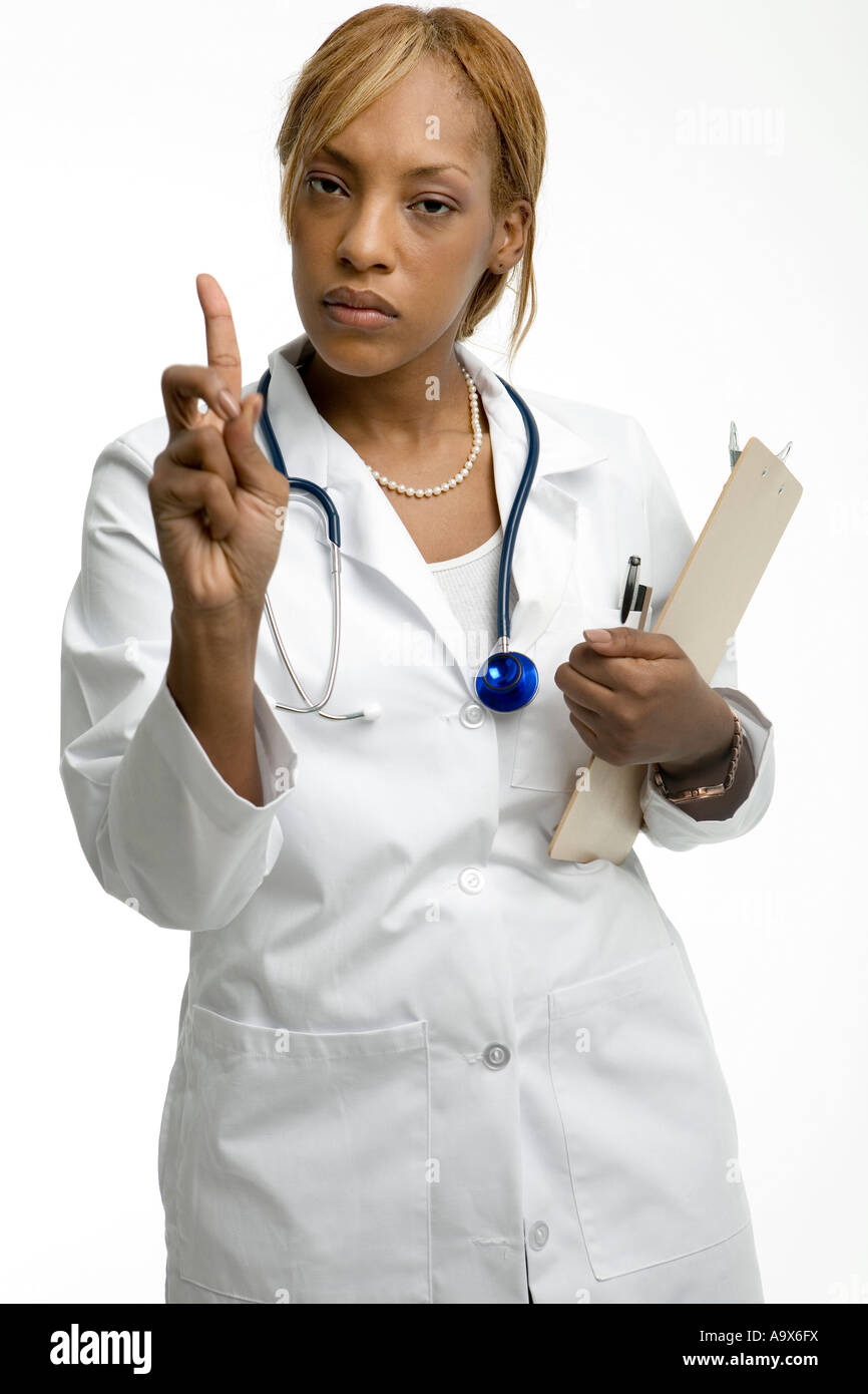 Young female doctor in a white coat and stethoscope admonishing a ...