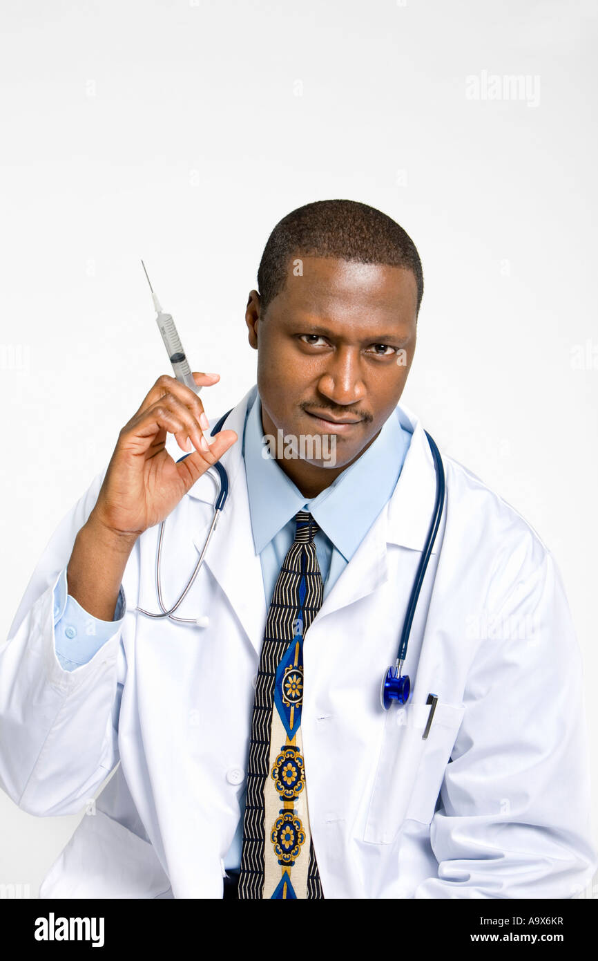 Sinister doctor in a white coat wielding a syringe Stock Photo - Alamy