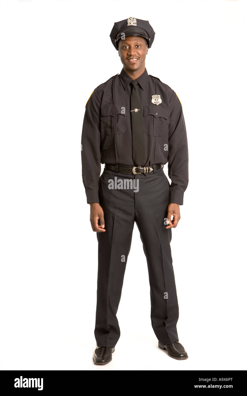 Young happy American policeman in full uniform standing up straight ...