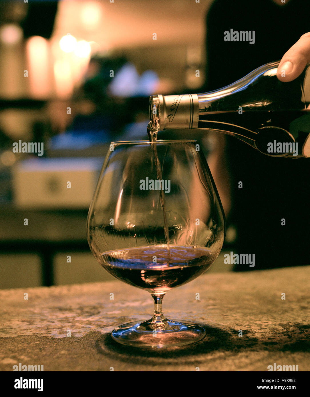 cocktail recipe mixing in a bar by professional barman in dark basement ...