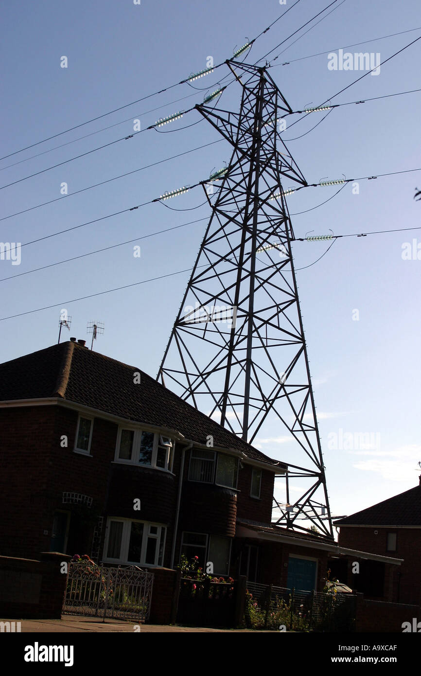 electricity pylon right on top of a suburban house in city suburbs ...