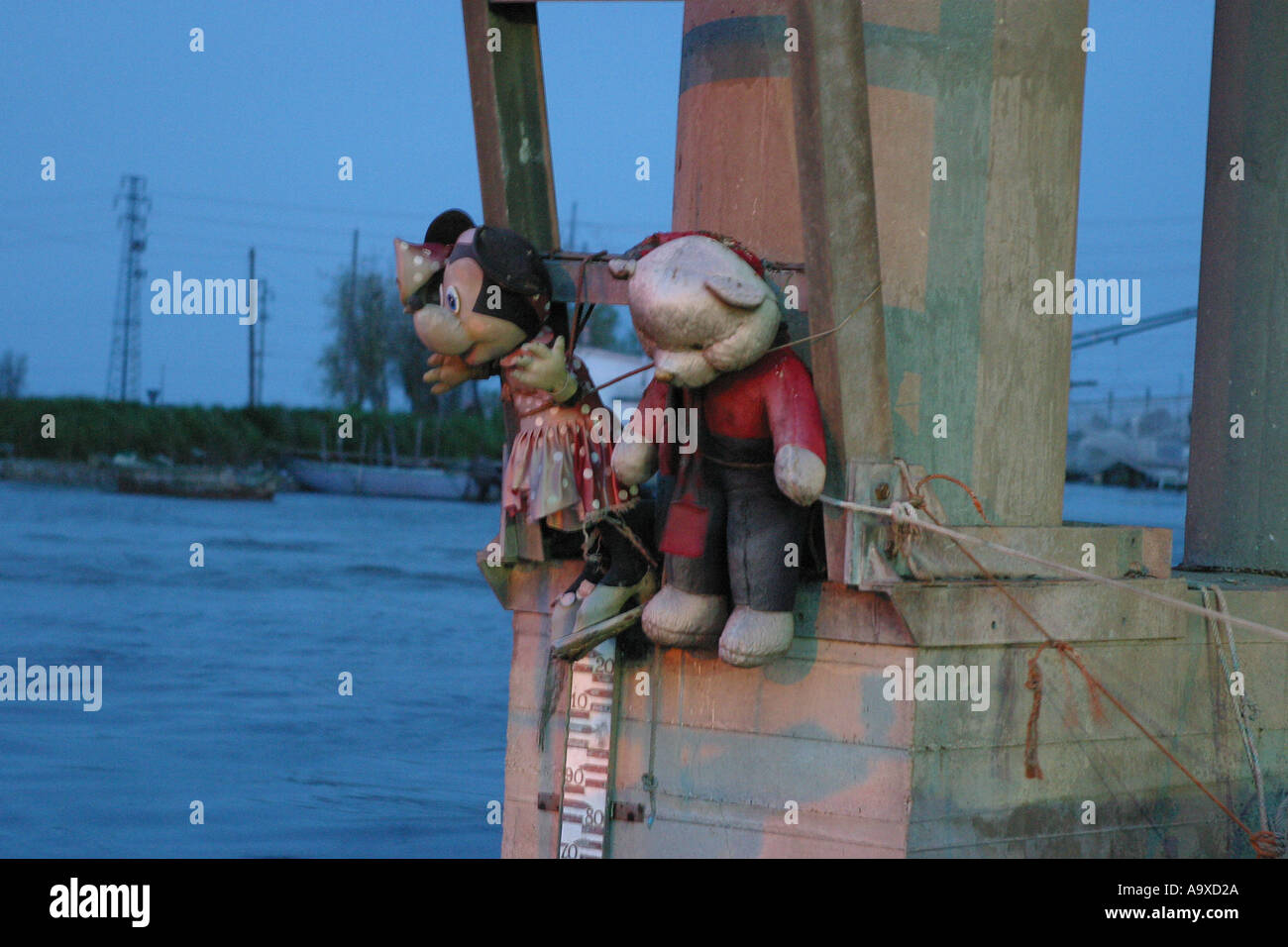 mini mouse and teddy bear tied to a bridge Stock Photo - Alamy