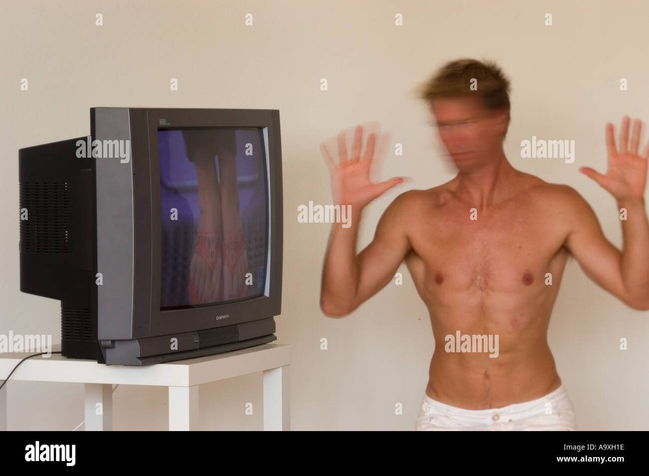 man going crazy with a television Stock Photo - Alamy