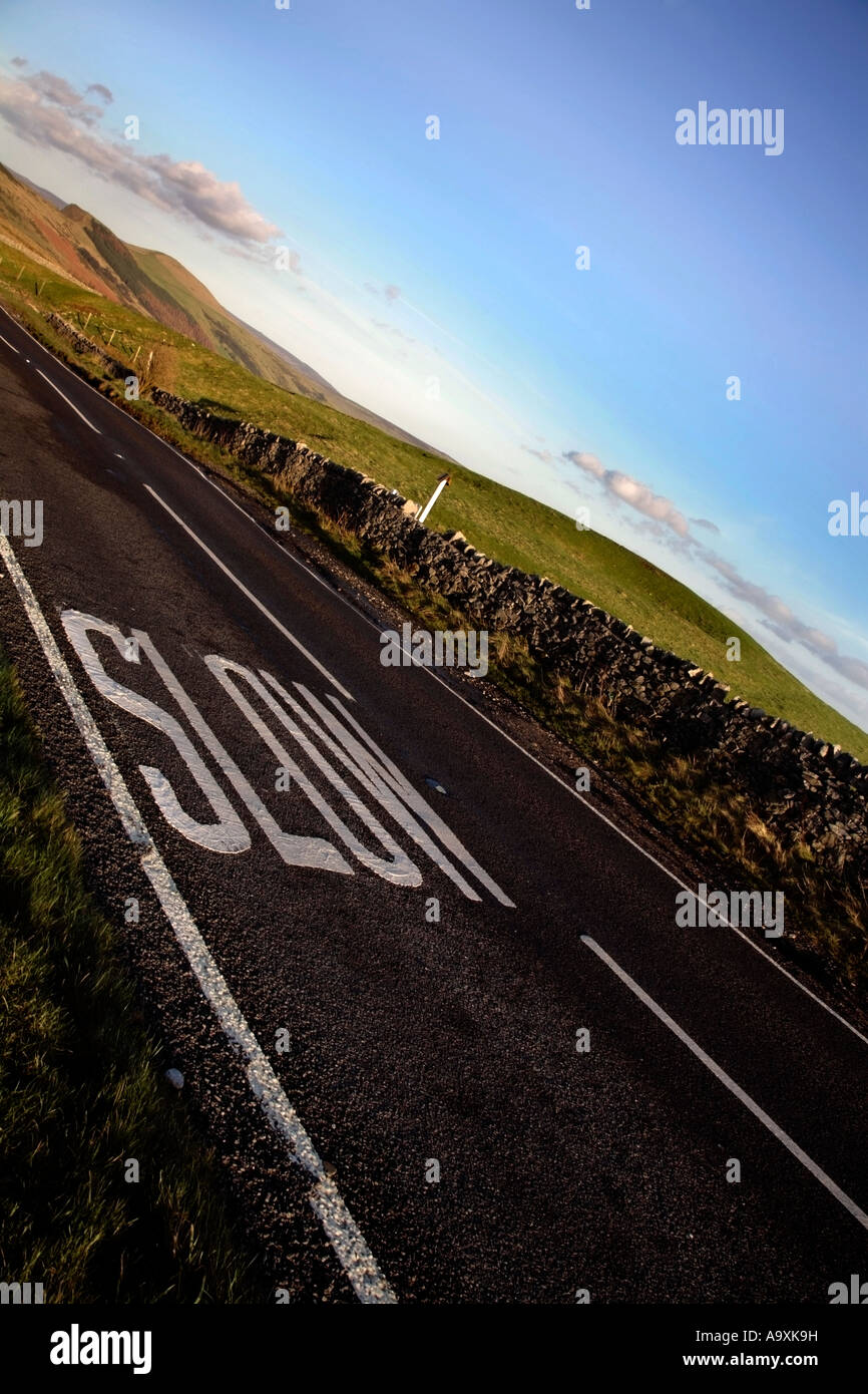 Slow road warning sign in the UK country side. SLOW road surface ...