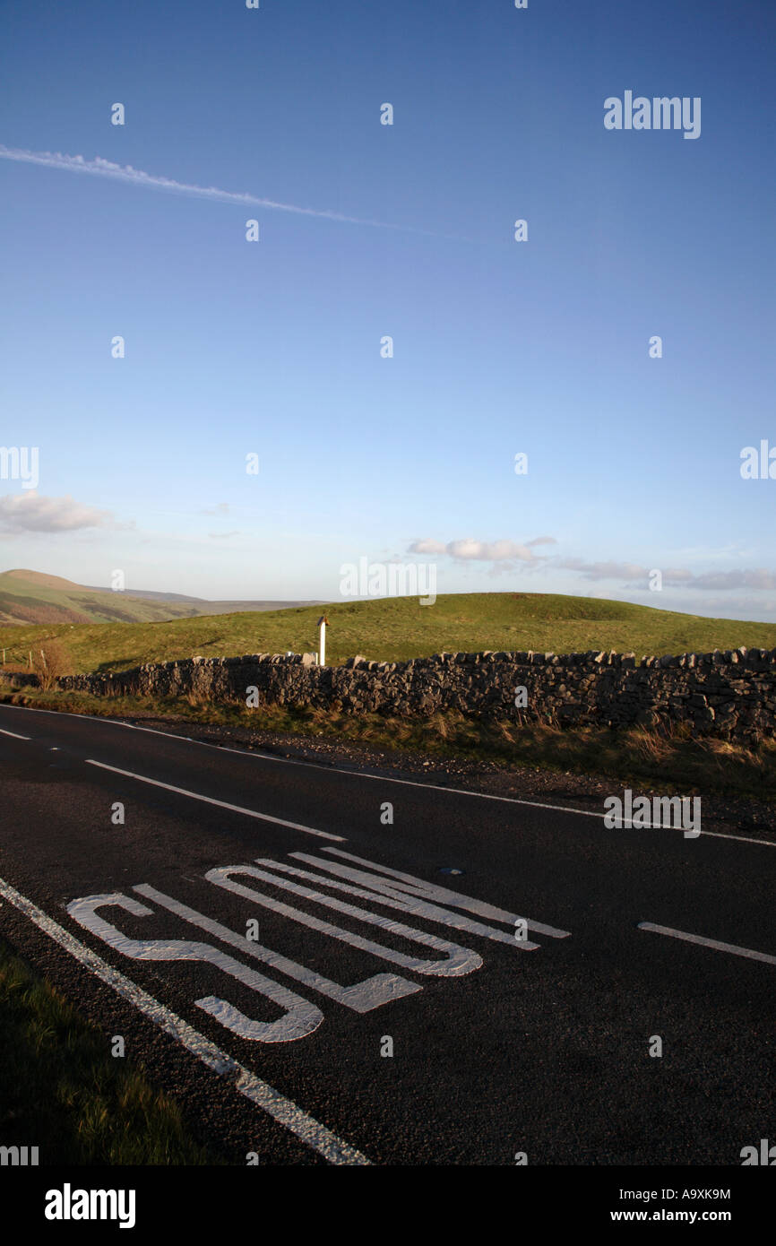 Slow road warning sign in the UK country side. SLOW road surface ...