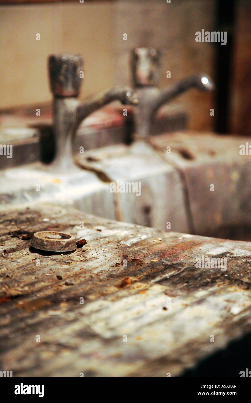 Old, dirty an rusty sink with two faucets and a plug Stock Photo - Alamy
