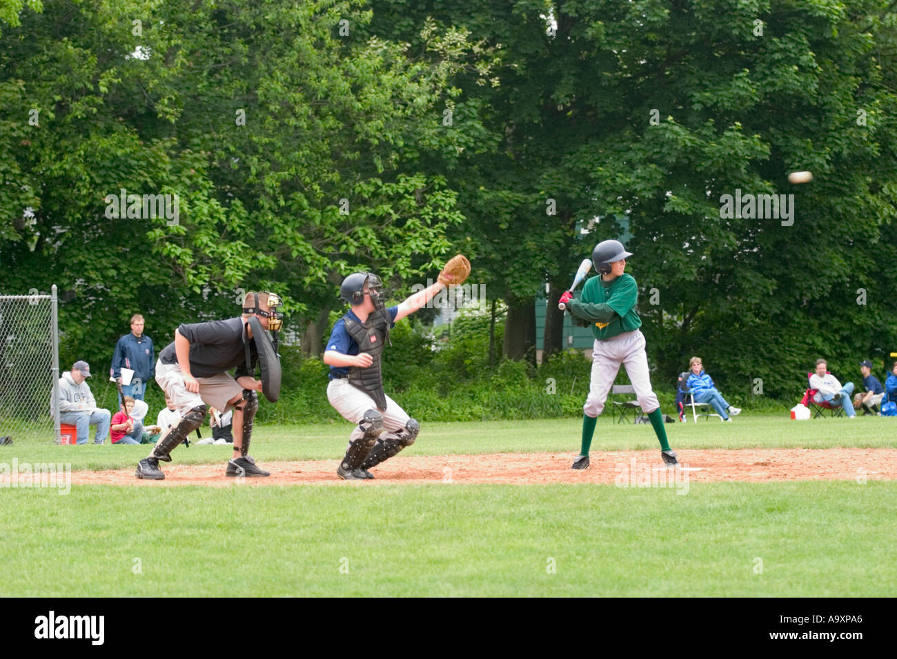Batter catcher and referee as a ball is being pitched during a Little ...