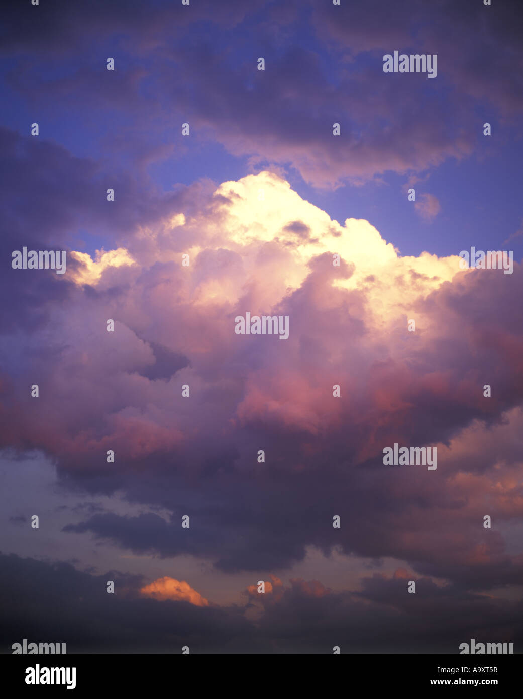 CLOUDSCAPE OF LARGE RED YELLOW ANVIL STORM CLOUDS ON BLUE SKY Stock ...