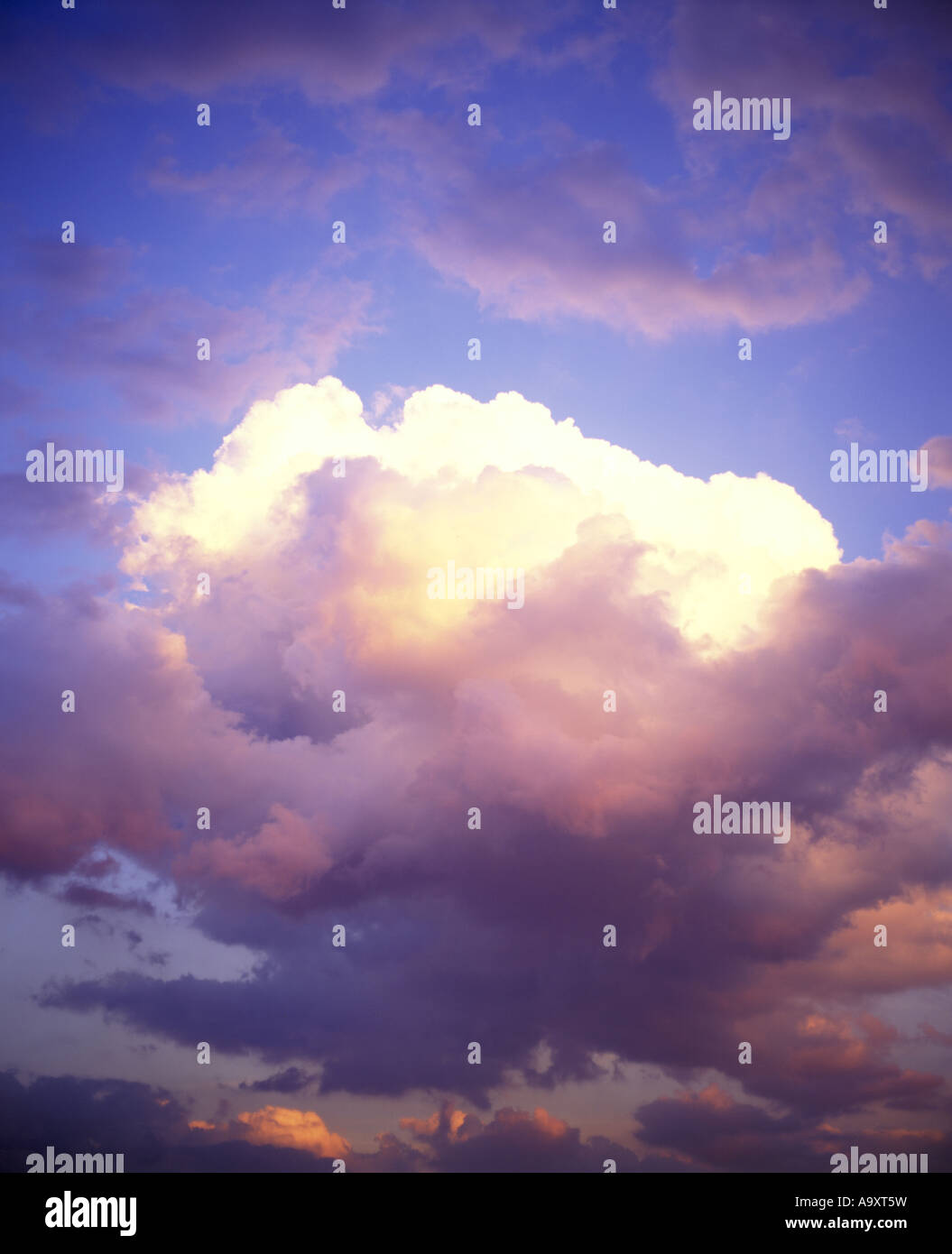 CLOUDSCAPE OF LARGE RED YELLOW ANVIL STORM CLOUDS ON BLUE SKY Stock ...