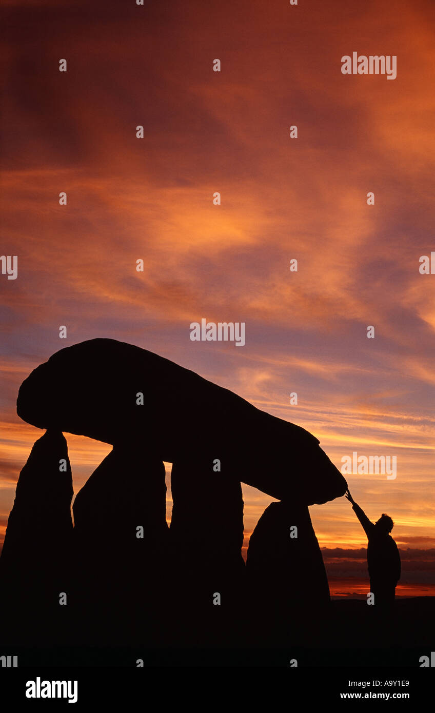 Man touching Neolithic stones at Pentre Ifan burial chamber Stock Photo ...