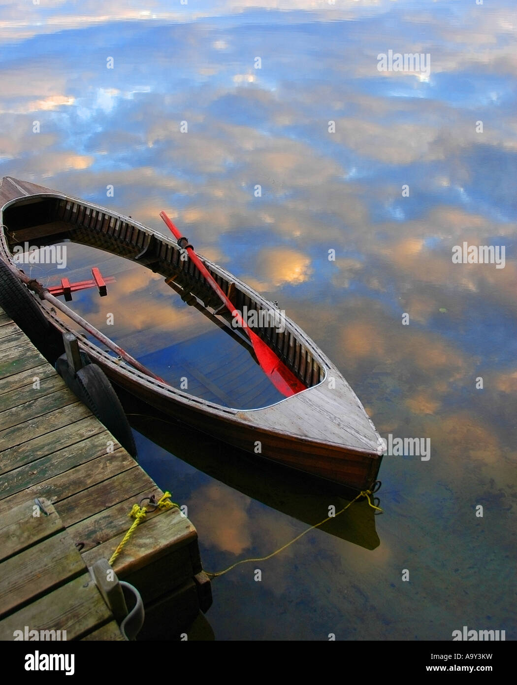 Empty Canoe On Shore with Cloud Reflection in Water Stock Photo - Alamy