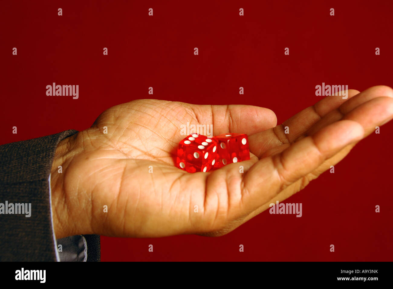 Businessman with dice in hand Stock Photo - Alamy