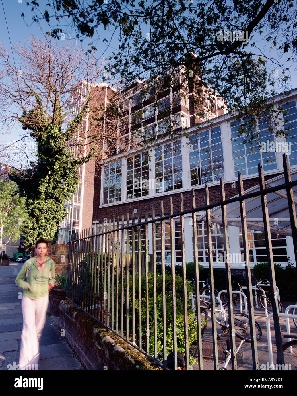 Female student walking home I on campus in London during the summer ...