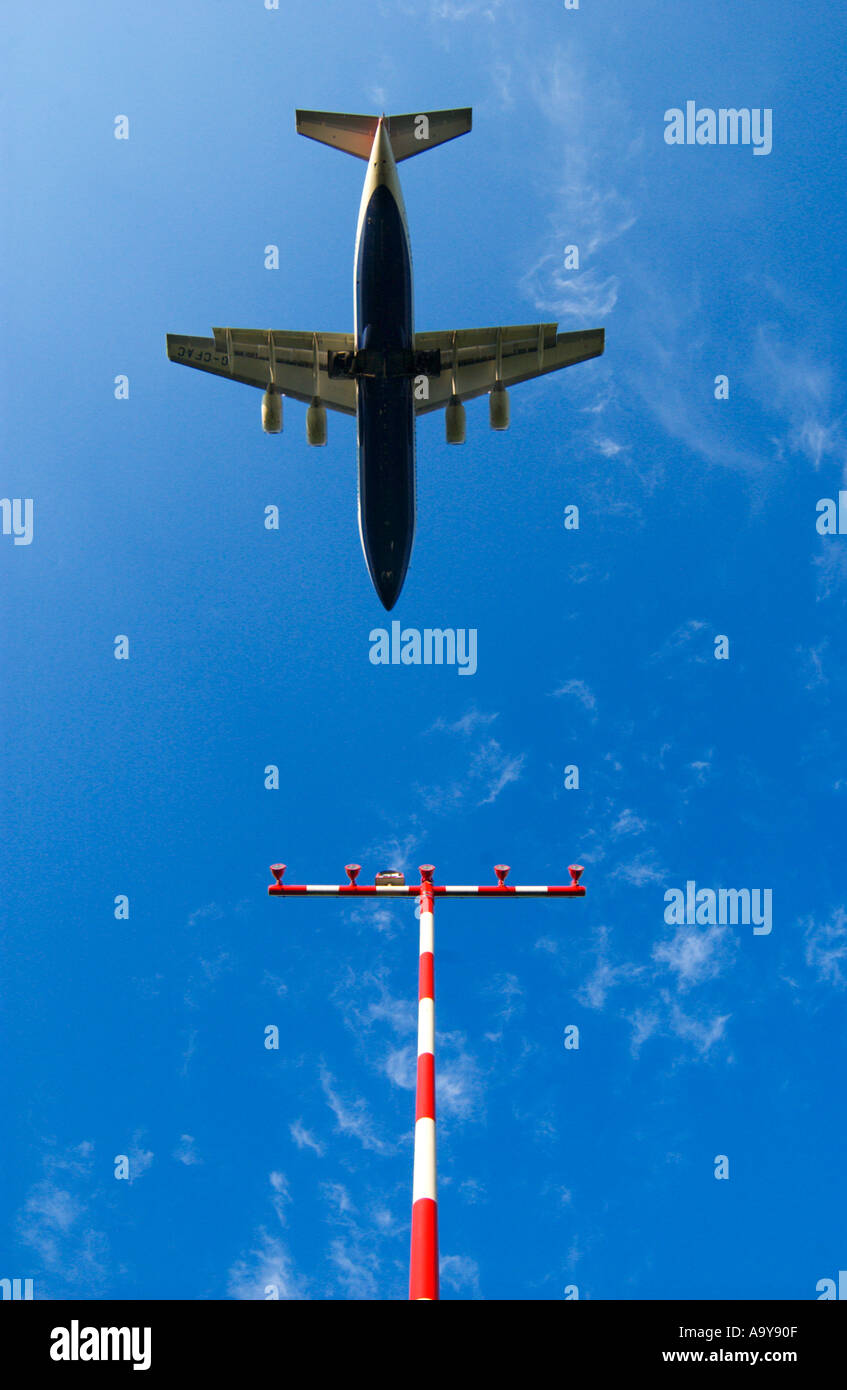 Passenger Plane flying over airport positioning lights Stock Photo - Alamy